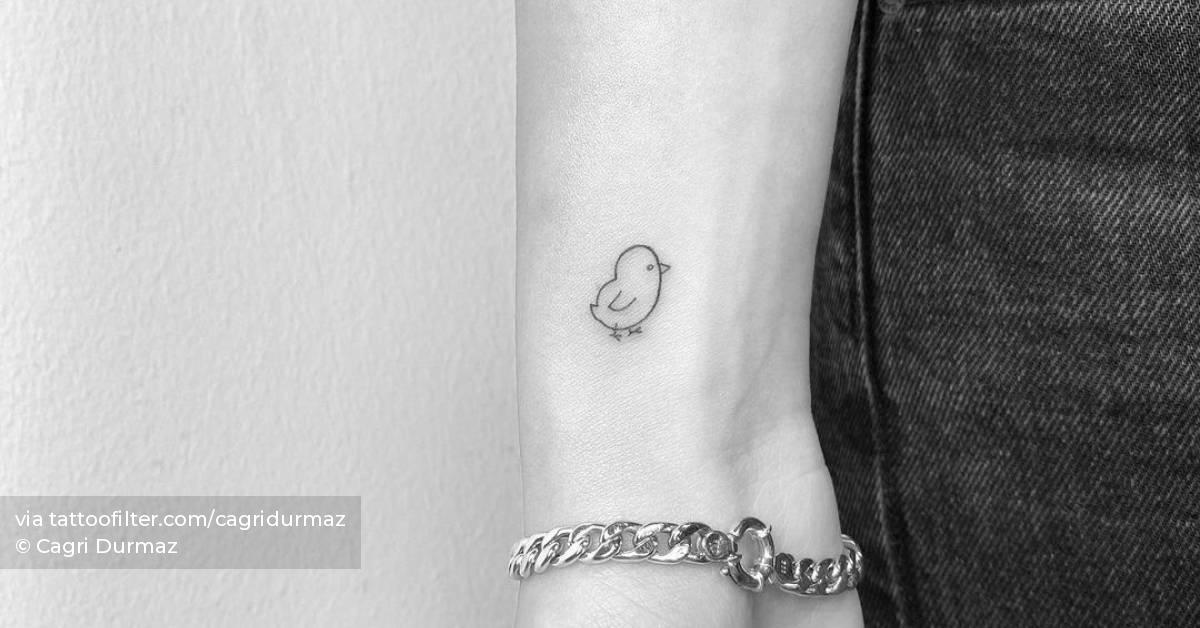 Minimalist chick tattoo on the wrist.