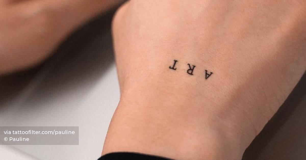 "Art" lettering tattoo on the hand.