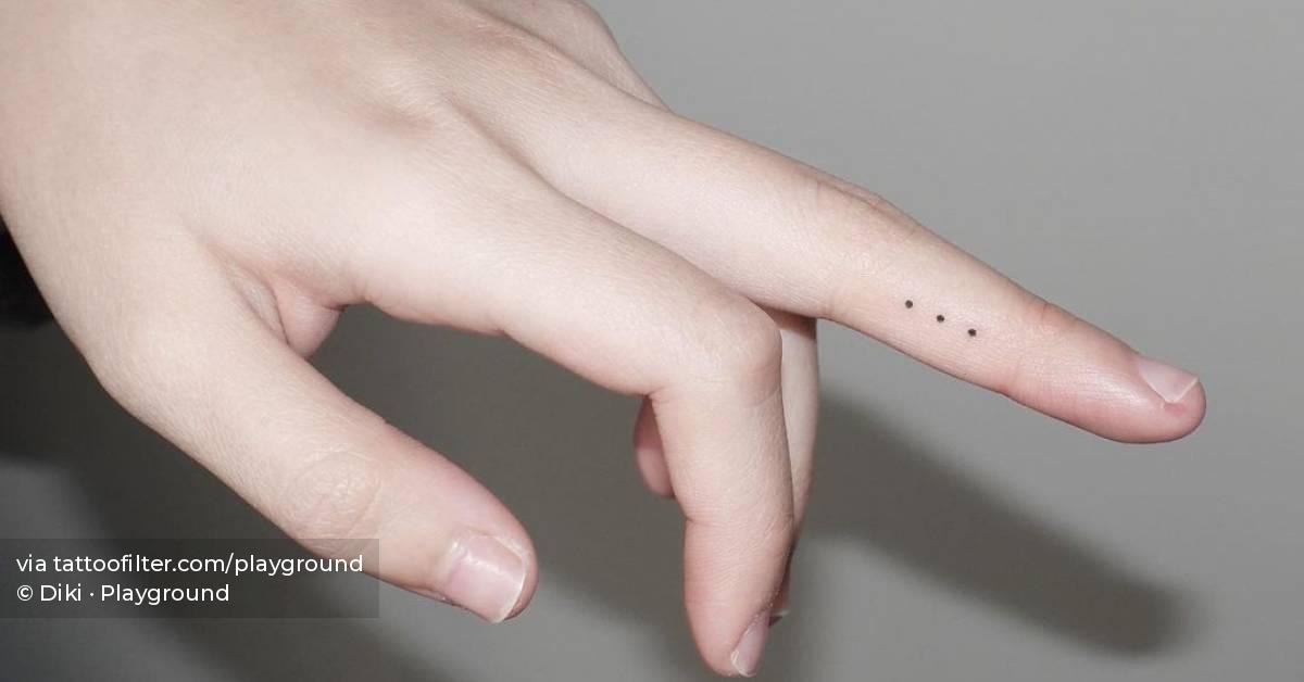Minimalist dots tattoo on the finger.