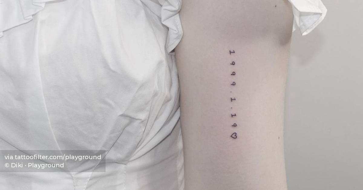 Date lettering tattoo on the bicep.