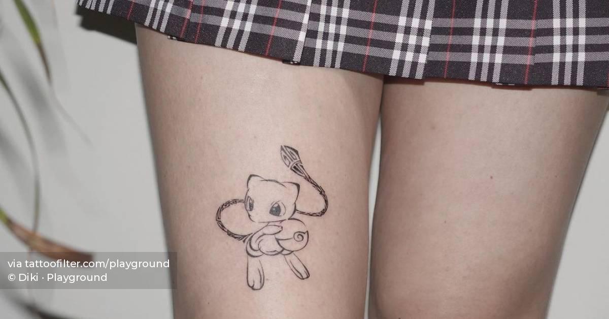 Mew tattoo on the thigh.