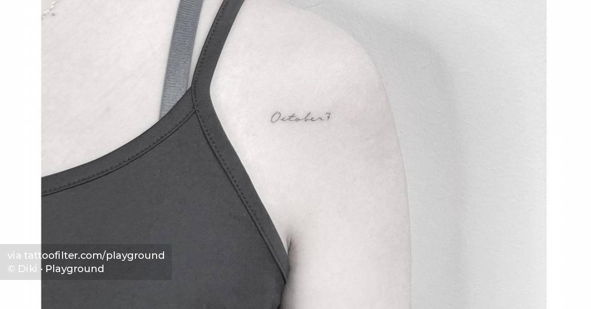 Date lettering tattoo on the shoulder.