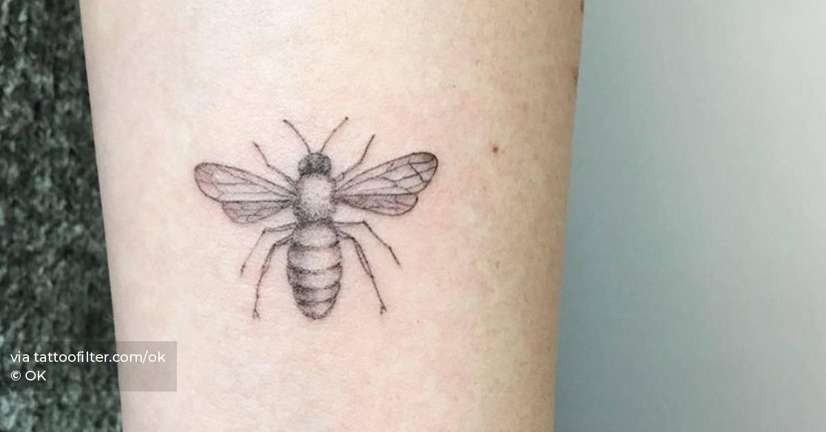Fine line bee tattoo on the inner forearm.