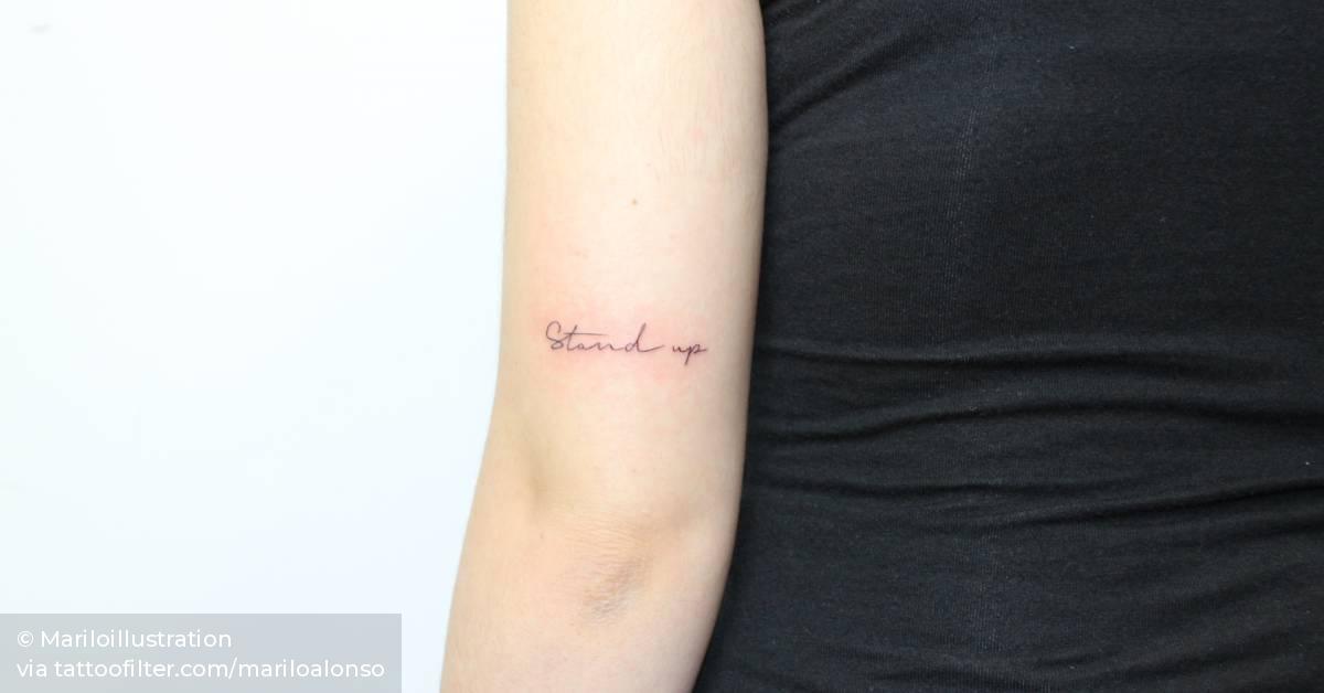 “Stand up” tattoo on the back of the left arm.