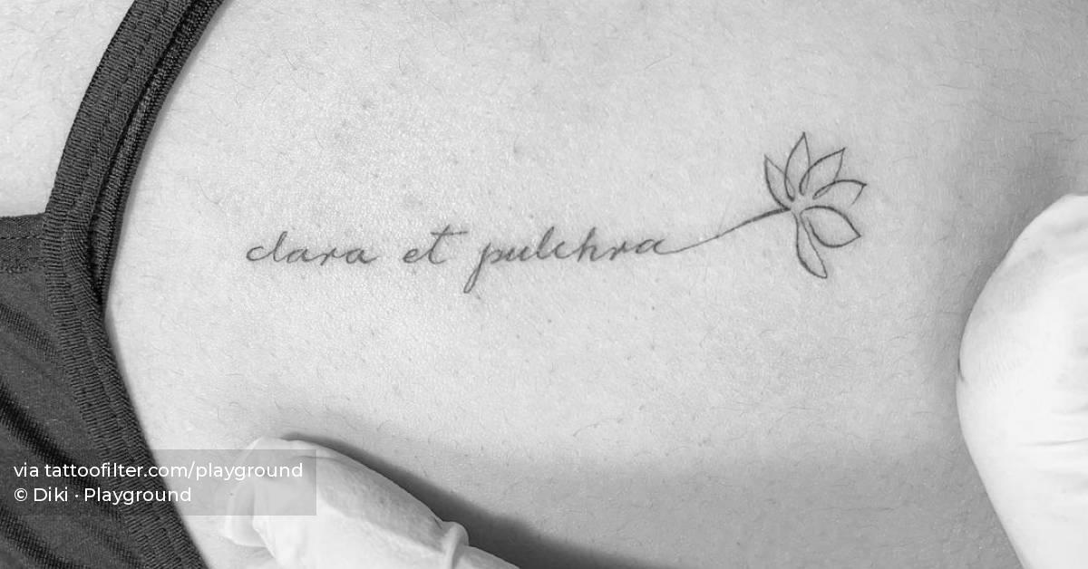 "Clara et pulchra" lettering tattoo on the shoulder