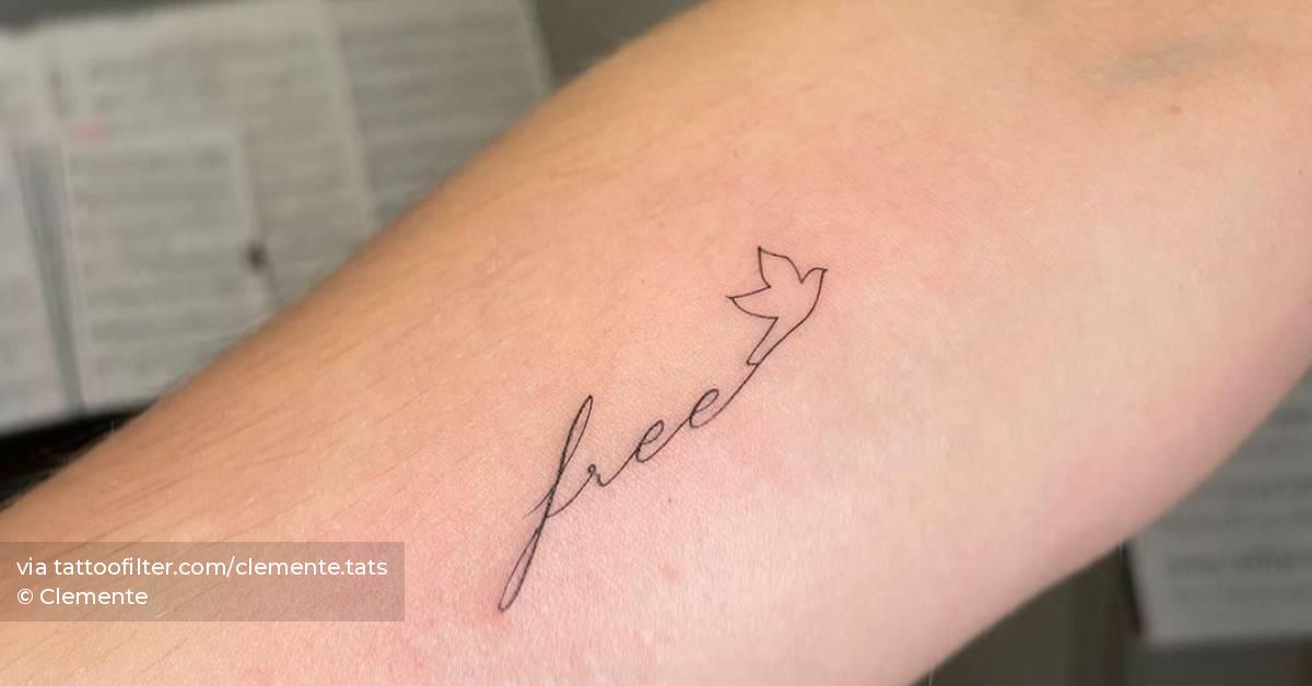 "Free" lettering tattoo on the inner forearm.