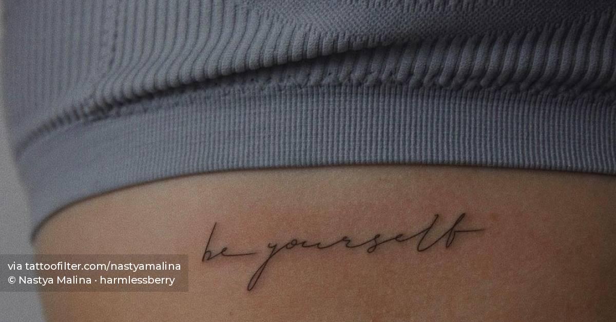 "Be yourself" lettering tattoo on the rib.