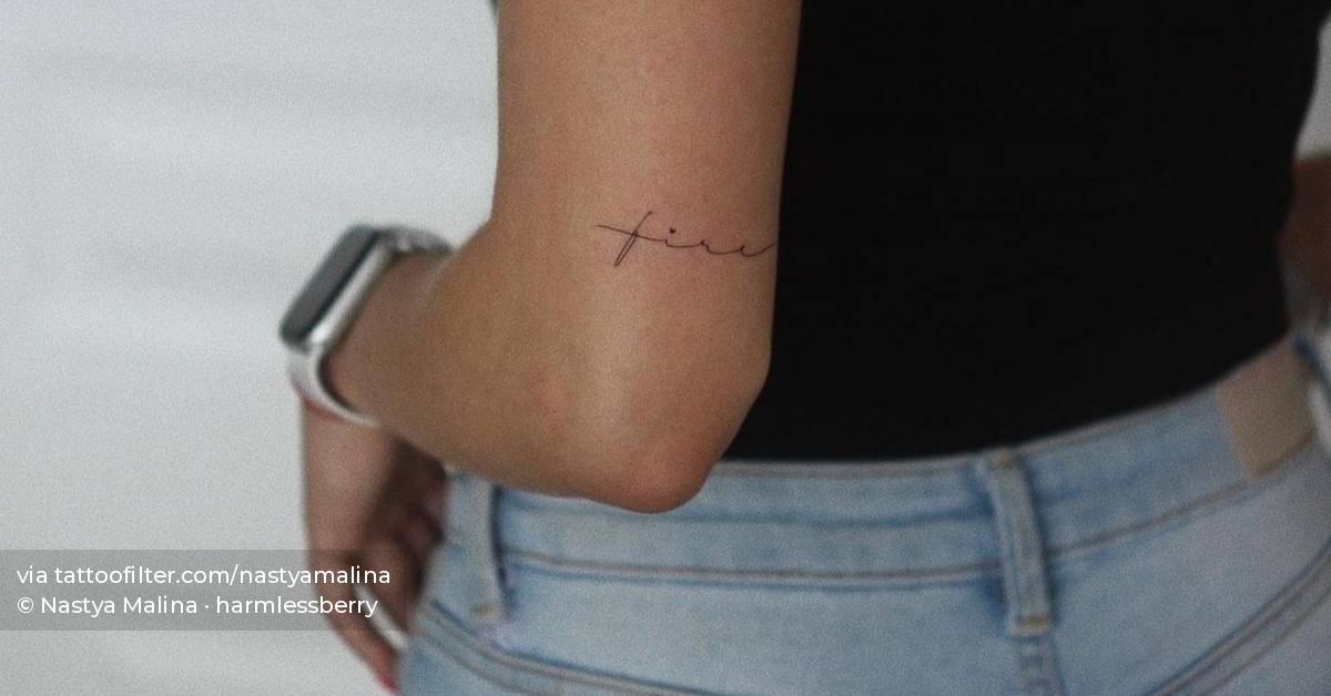 "Fire" lettering tattoo on the tricep.