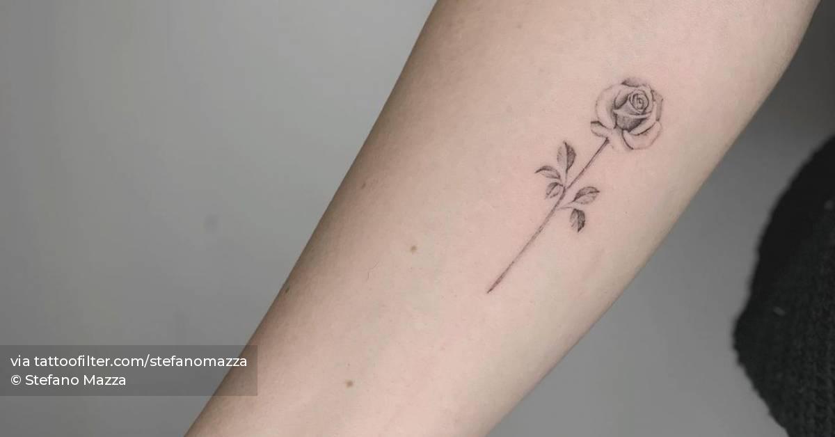 Micro-realistic rose tattoo on the inner forearm.