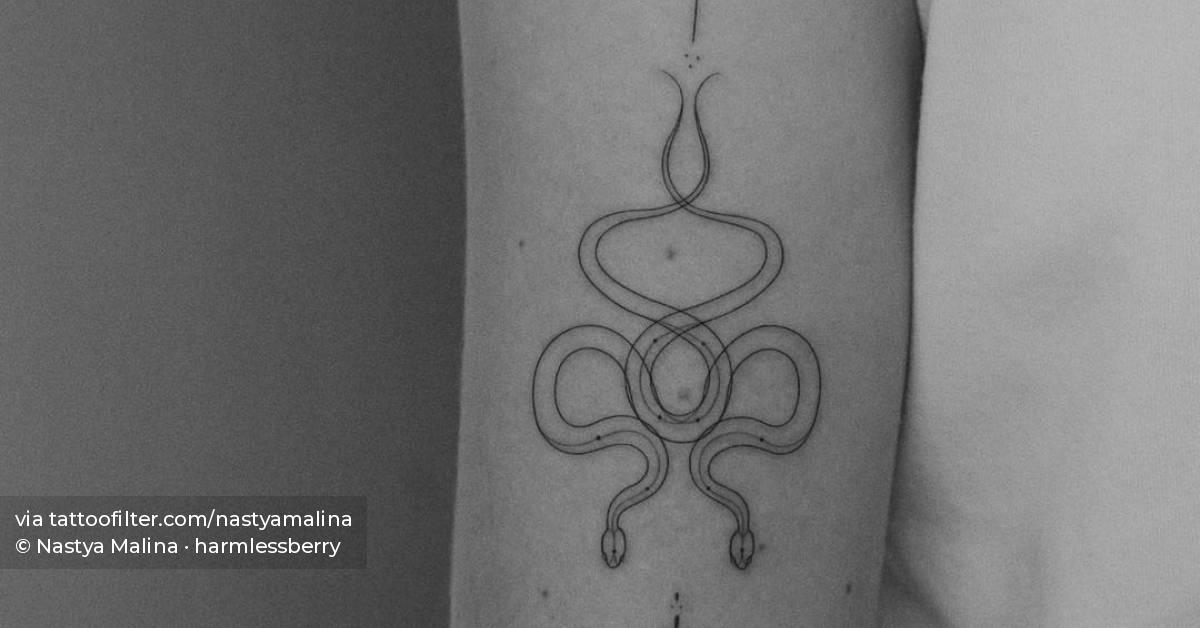 Fine line snakes tattoo on the tricep.