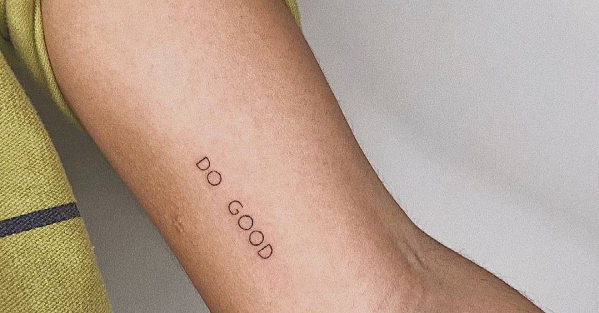 "Do good" hand poked lettering tattoo on the inner arm.