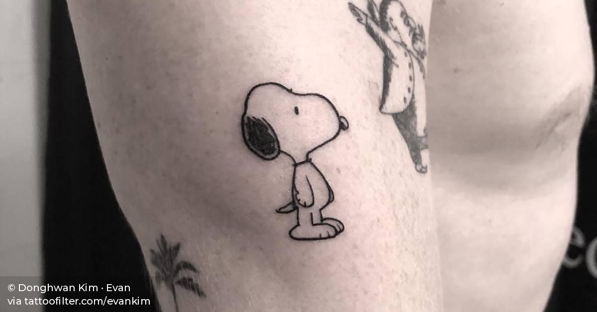 Snoopy tattoo on the right upper arm.
