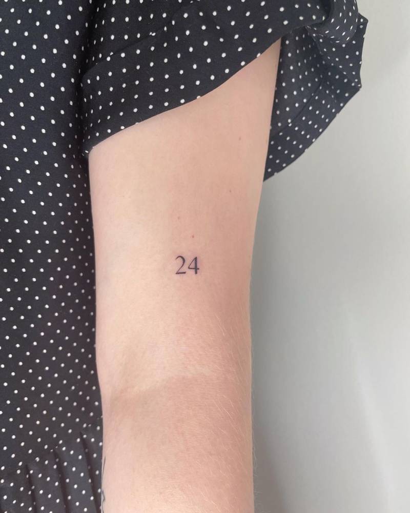 Tiny Number 24 Tattooed On The Upper Arm 