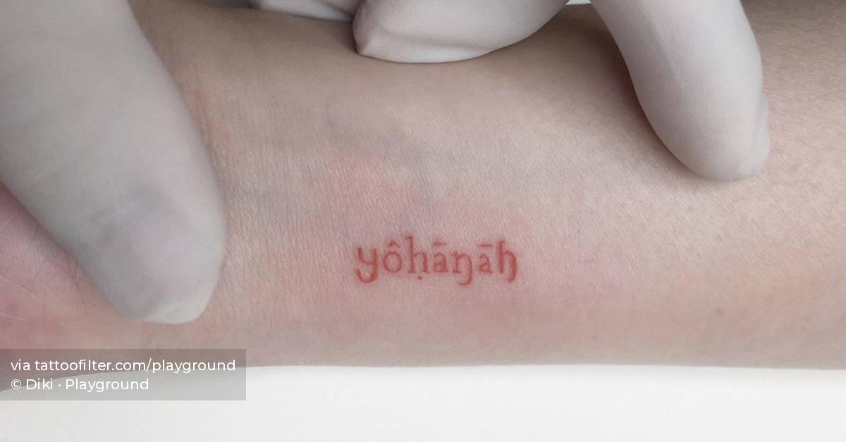 Name tattoo done in red ink and located on the wrist.