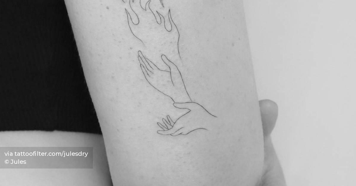 Tattoo of hands on fire placed on the tricep, done in