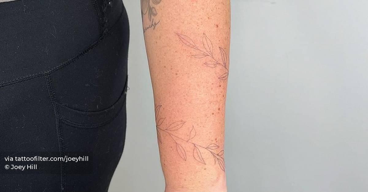 Single needle leaves bracelet tattoo placed on the