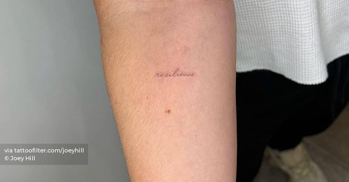 "Resilience" lettering tattoo on the inner forearm.