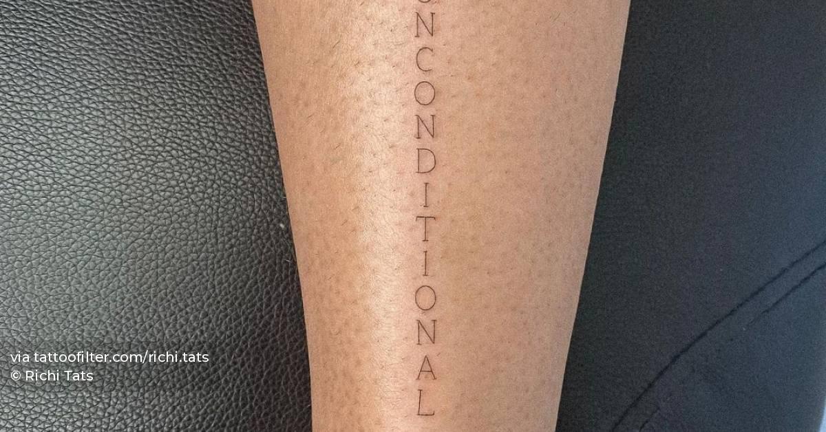 "Unconditional" lettering tattoo located on the
