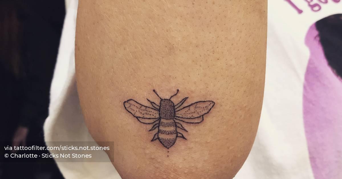 Elbow tattoo of a bee, hand poked.