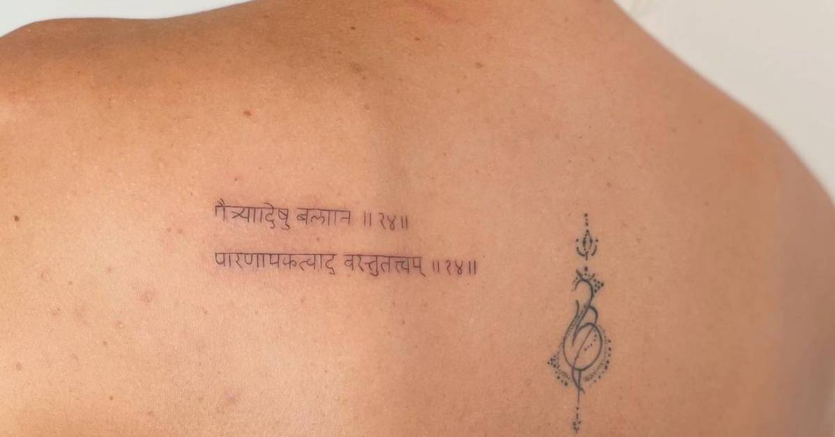 Yoga sutras tattooed on the shoulder blade.