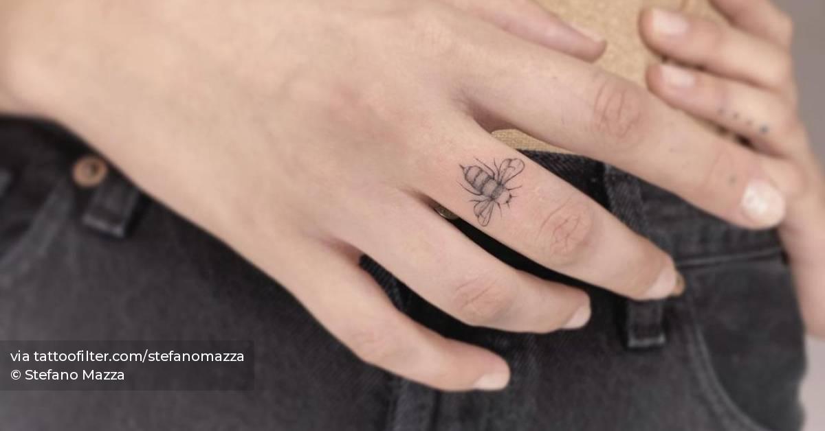 Little fine line bee tattoo placed on the finger.