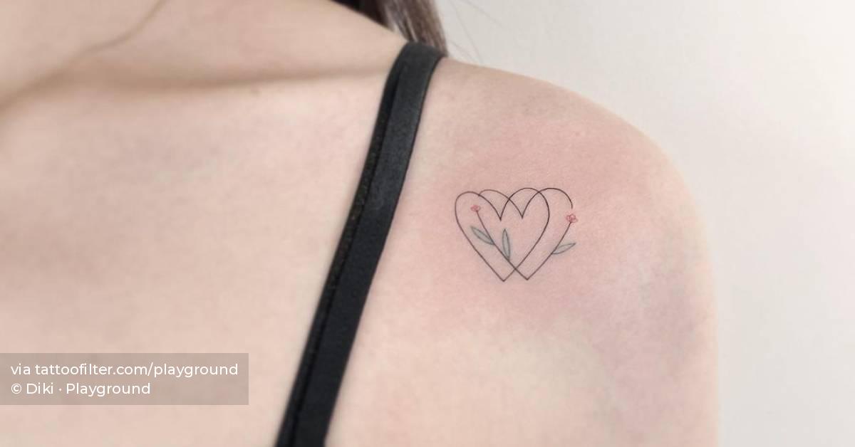 Fine line heart and flower tattoo on the shoulder.