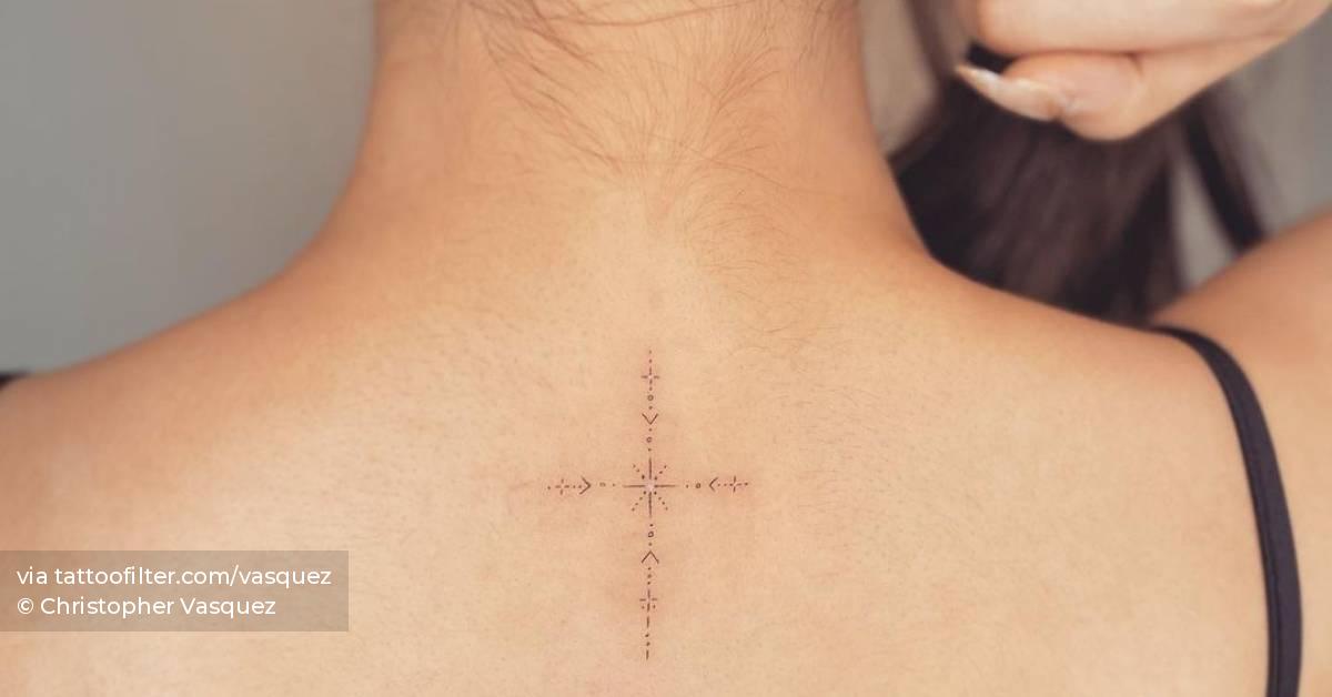 Fine line ornament tattooed on the upper back.