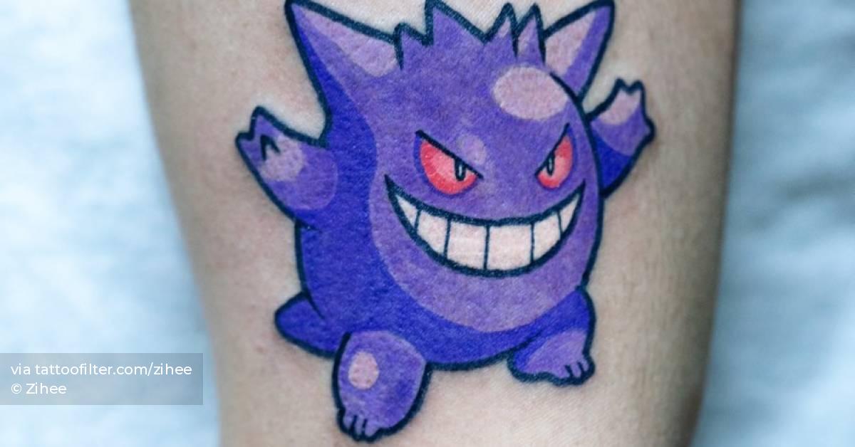 Colorful Gengar tattoo done on the upper arm.