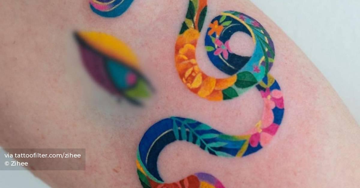 Original snake design tattoo located on the inner arm.
