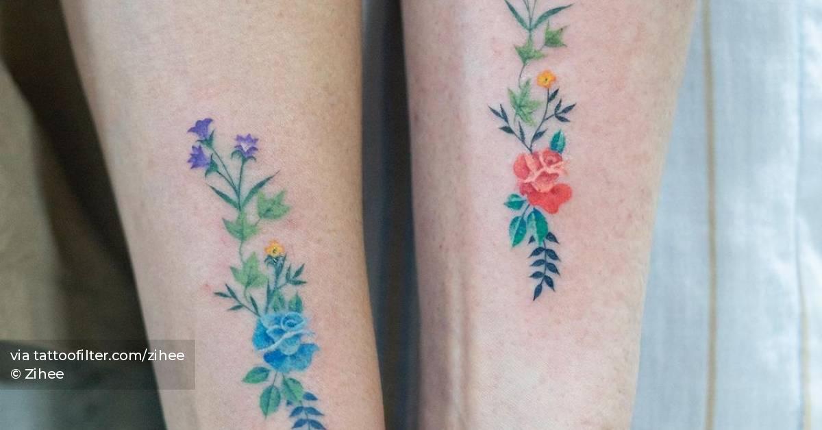 Matching flowers tattooed on sisters.