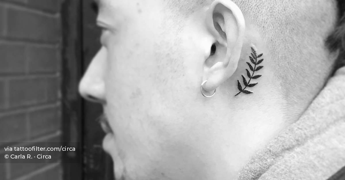 Leaves tattoo located behind the ear.