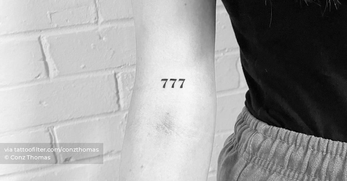 Lucky number "777" tattooed on the bicep.
