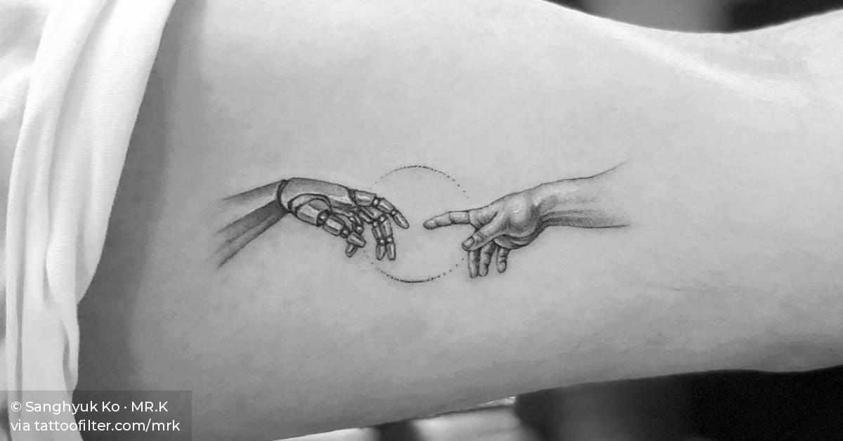 The creation of Adam adaptation on the left inner arm.
