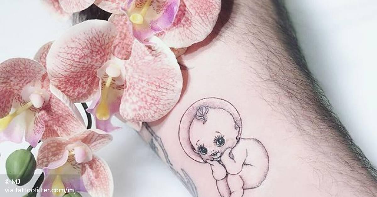 Kewpie tattoo on the inner forearm.