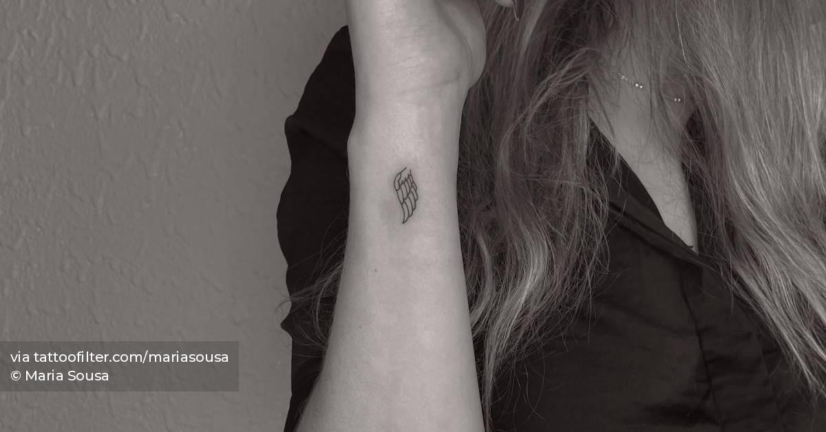 Fine line wing tattoo located on the wrist.