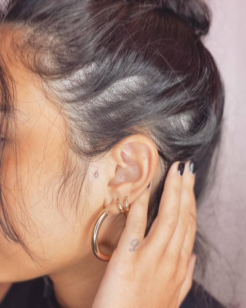 Tiny Number 6 Tattoo Located On The Face 