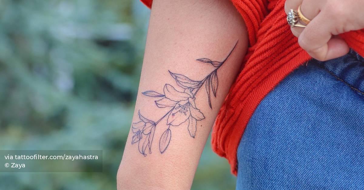 FIne line lily flower tattoo located on the forearm.