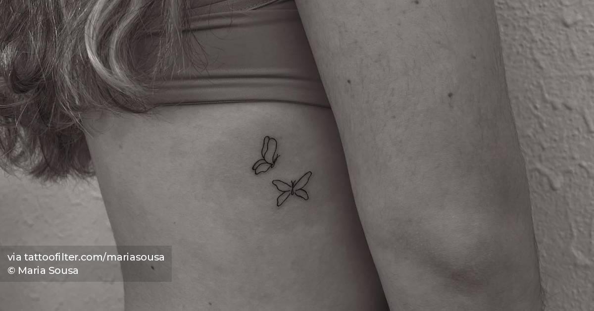 Minimalistic butterfly couple tattoo placed on the rib.