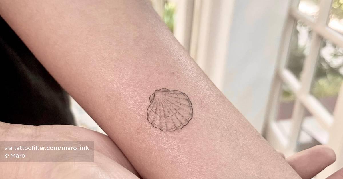 Fine line shell tattoo done on the inner forearm.