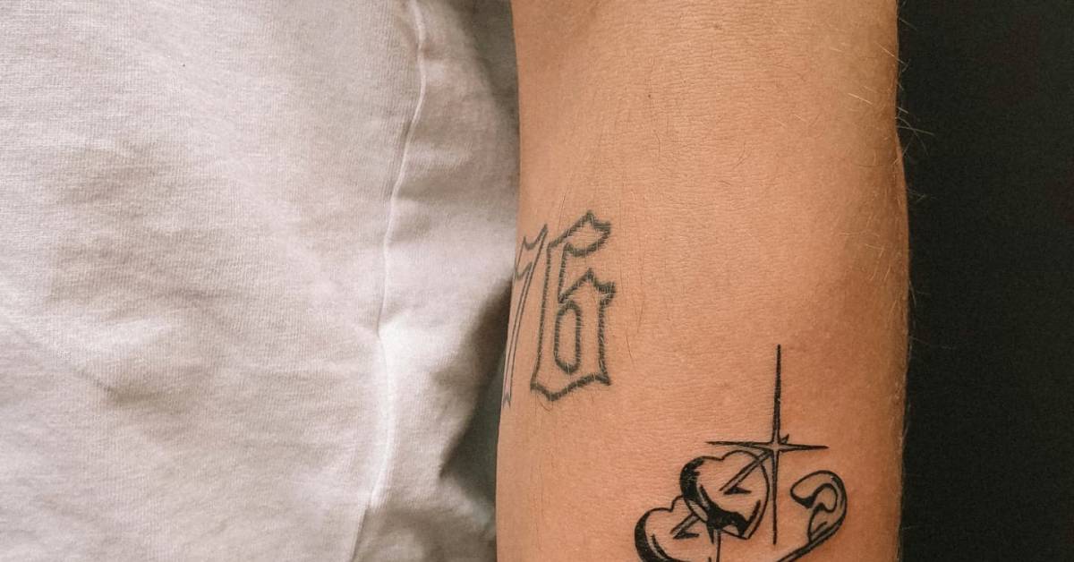 Safety pin tattoo located on the forearm.