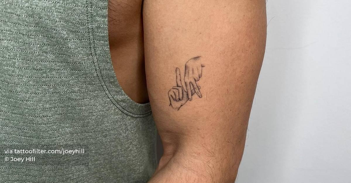 Healed "LA" tattoo done on the upper arm.