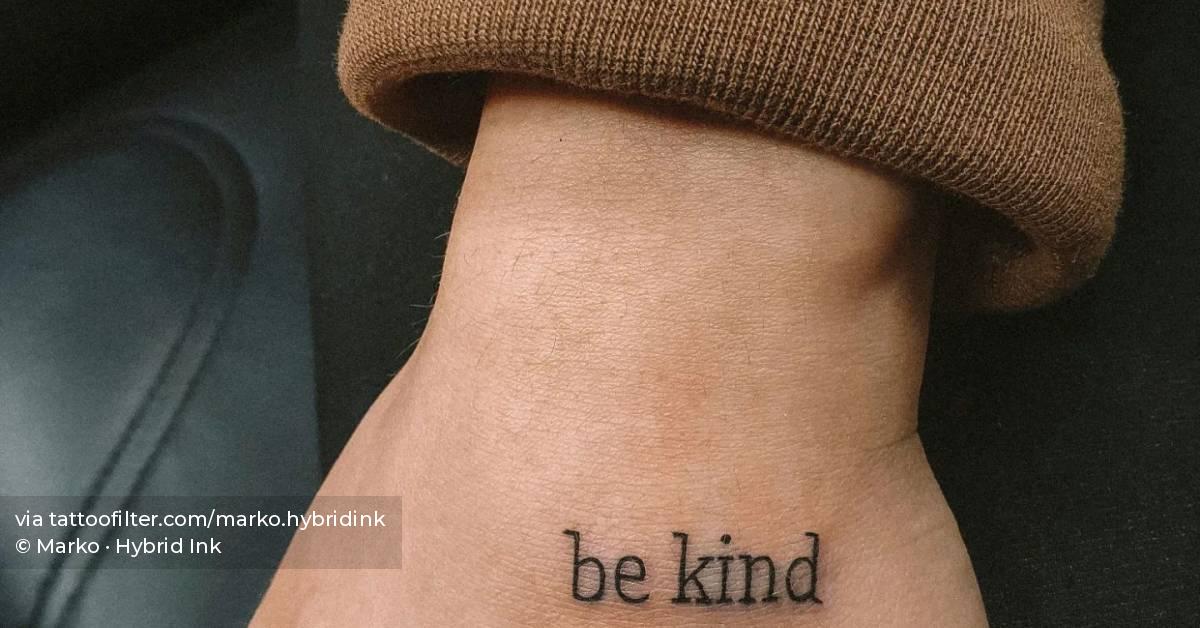 Tattoo that says "be kind" done on the hand.