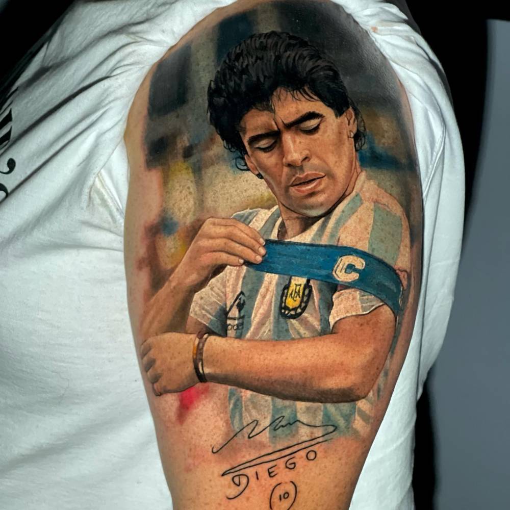 Realistic Maradona Portrait Tattoo Located On The Upper