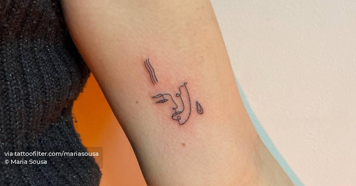 Fine line face tattoo on the inner arm.