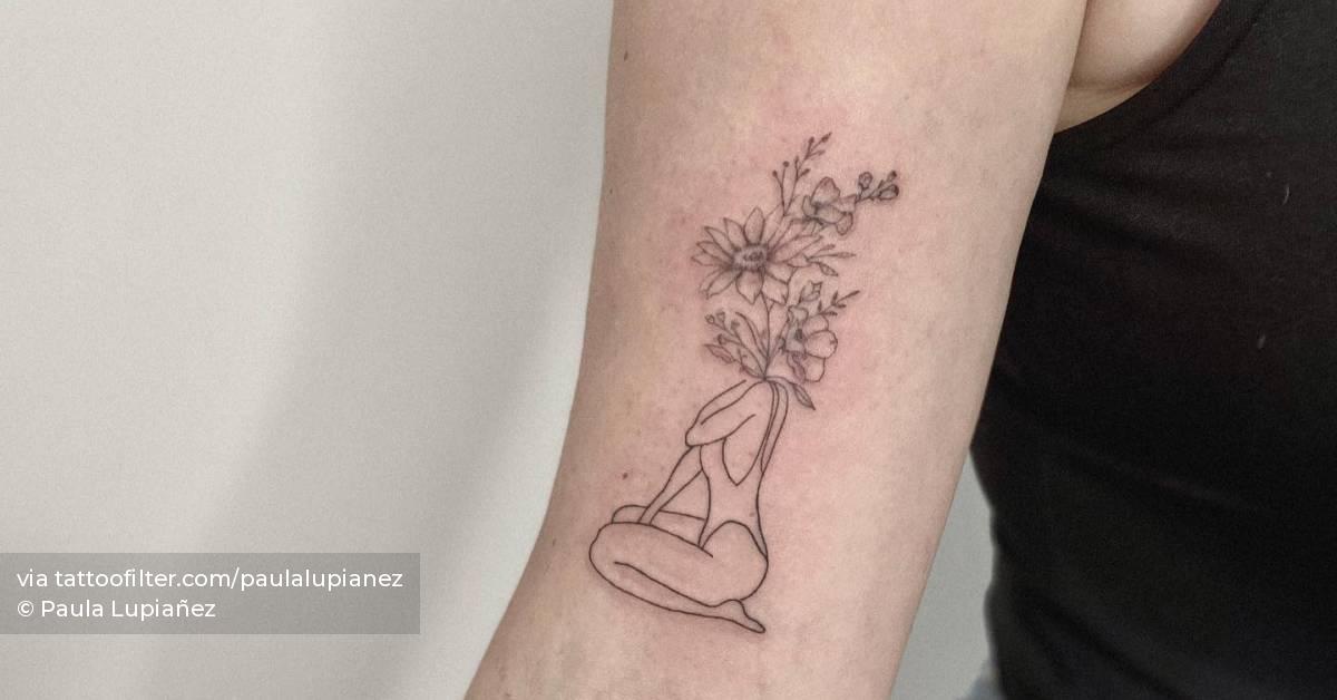 Flower head woman tattoo located on the bicep, fine