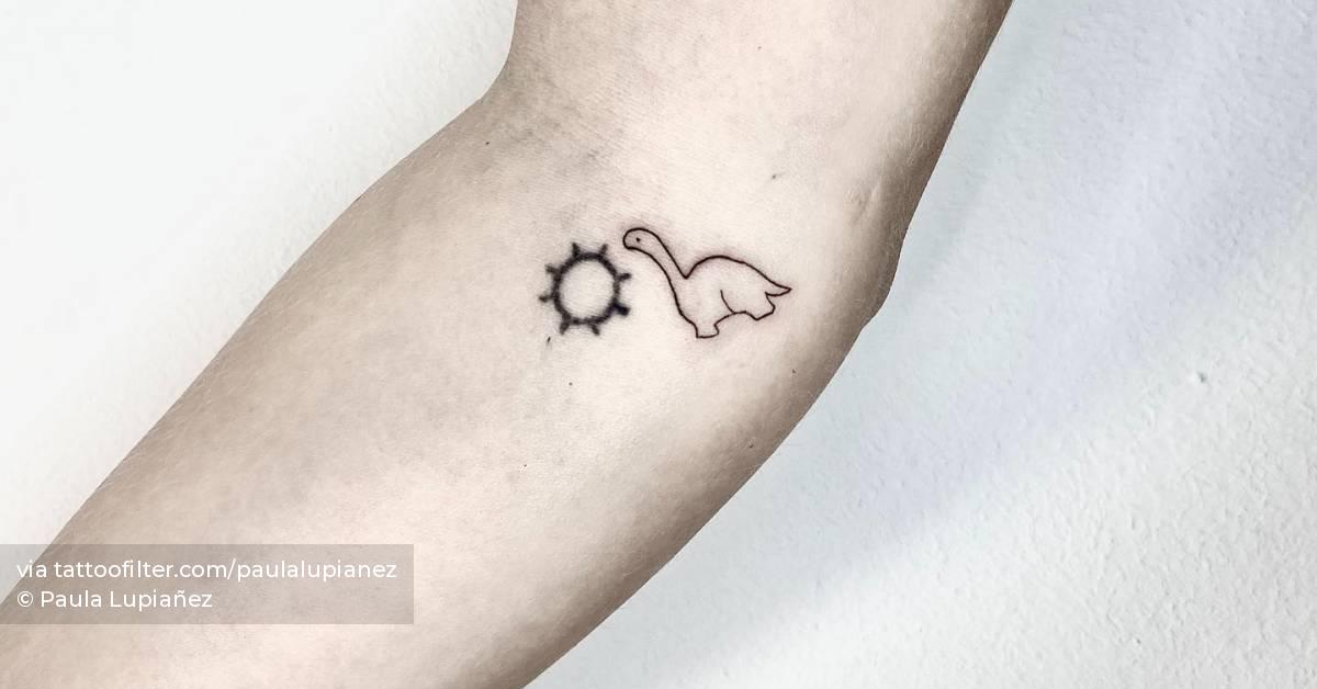 Minimalistic brontosaurus tattoo located on the elbow.