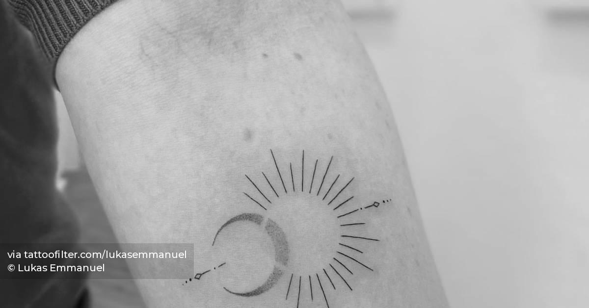 Fine line sun and moon tattoo on the inner forearm.