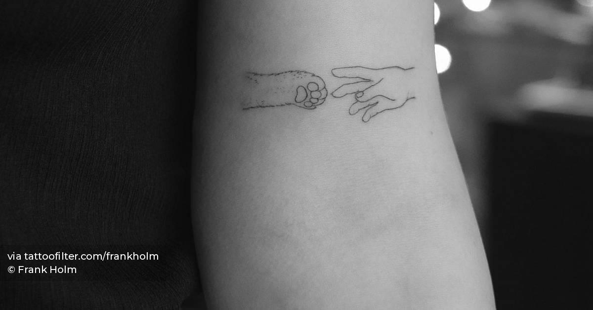 Fine line hand and paw tattoo for a cat lover.