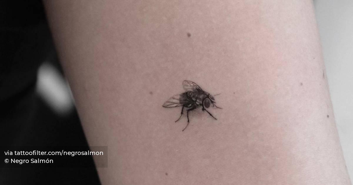Micro-realistic fly tattoo located on the inner arm.