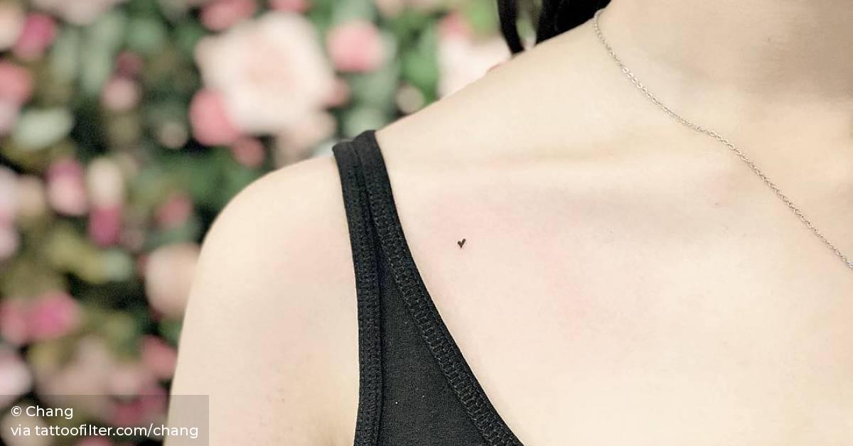 Micro heart tattoo on the collarbone.